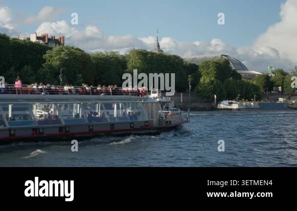 Tourists on a passenger sightseeing cruise boat sail along the Seine ...