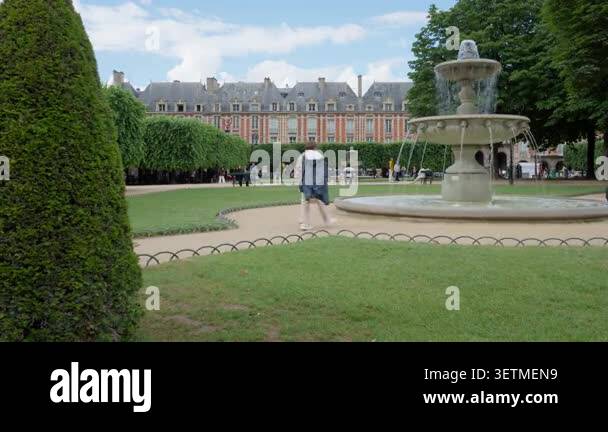Tourist woman sightseeing at Place des Vosges public square park in ...