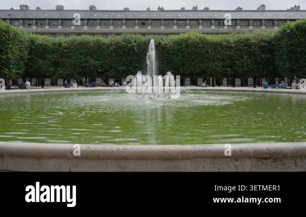 Palais Royal garden fountain sprays water in Paris France. Historic ...
