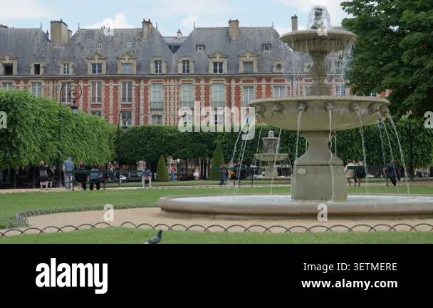 Place des Vosges public square park fountain with flowing water in ...