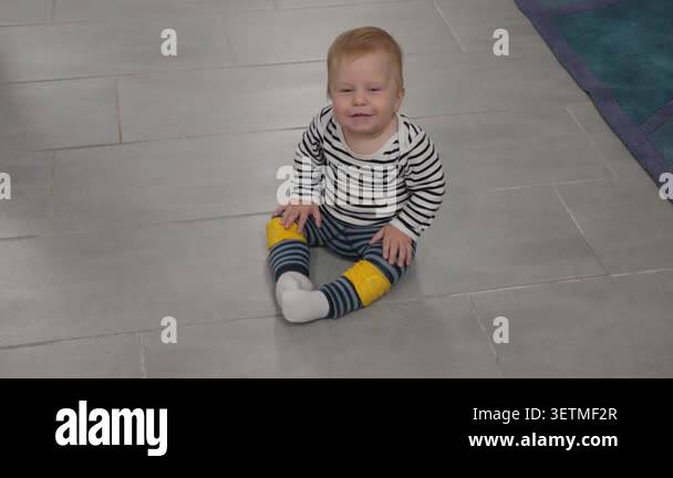 Happy child explores surroundings. Toddler cautiously inches forward ...