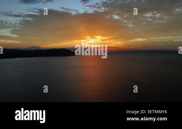 Balige, Indonesia - May 29, 2025: Cinematic aerial view of sunset at ...