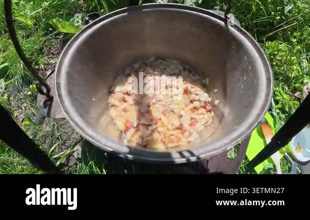 Frying chopped onions and lard in cauldron Stock Video Footage - Alamy