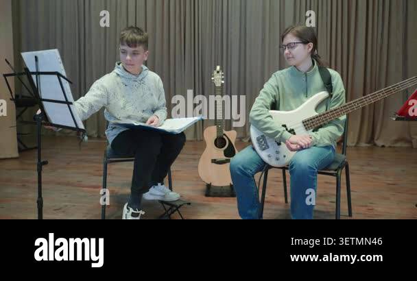 Boy and Girl Practice Playing Music on Stage. Kids Play Guitar and Bass ...