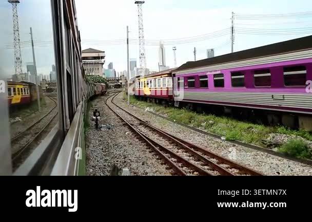 View from a train window showing train cars on a curved railway track ...