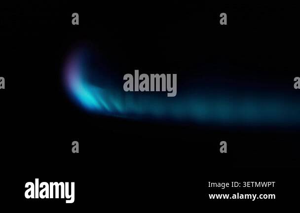 Detailed macro shot of a gas stove burner emitting a steady blue and ...