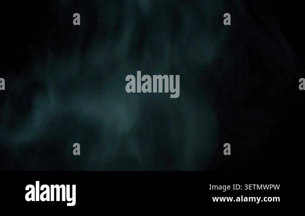 Ethereal white and cyan smoke swirls gracefully against a dark black ...