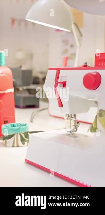 Empty sewing workshop classroom with modern machines on a long white ...