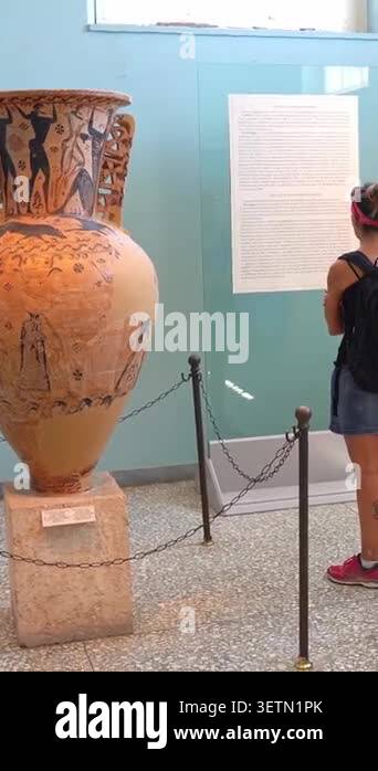 Eleusis, Greece, August 30, 2019 Young tourist with a backpack admiring ...