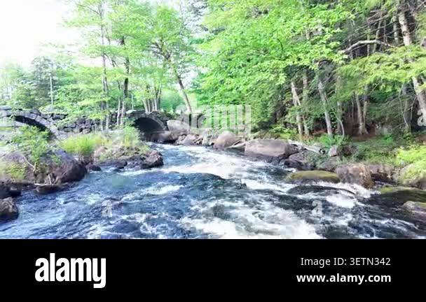 Floating down a small stream on a sunny spring day toward a historic ...