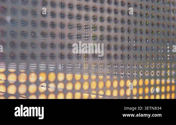 Close-up texture of a gray metallic grid pattern featuring circular ...