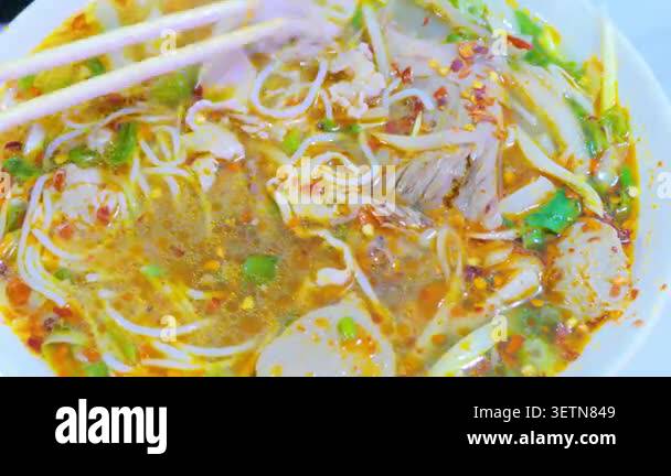 Spicy bun bo hue Vietnamese beef noodle soup bowl with chopsticks Stock ...