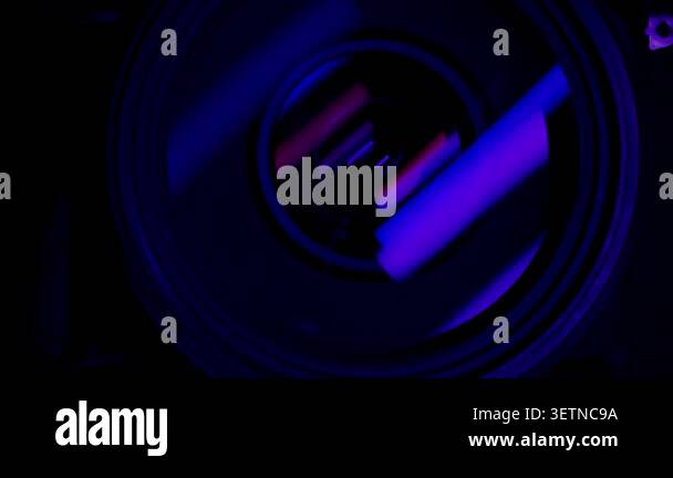 Abstract blue neon light reflections on camera lens glass elements ...