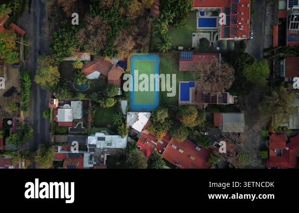 Aerial drone slowly rotates while descending toward an overhead view of ...