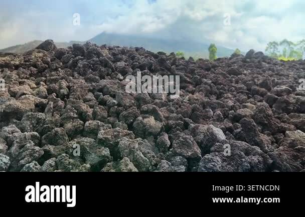 Gimbal stabilization zoom out shot of Mount Batur volcanic black lava ...