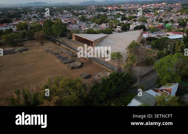 Aerial drone slowly approaches the Teopanzolco Cultural Center in ...