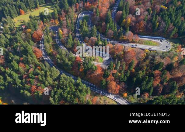 High-angle aerial drone view of a winding serpentine mountain road ...