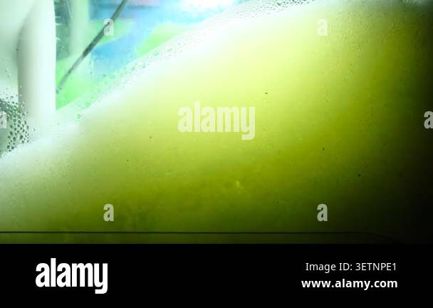 Ice cold sorbet machine mixing fruit juice. Freezing slush spinning ...