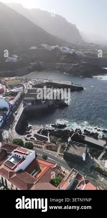 Drone aerial view of Garachico harbor, volcanic coastline and mountain ...