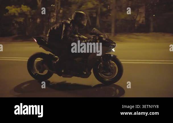 Young motorcyclist riding fast on powerful sport motorbike at evening ...