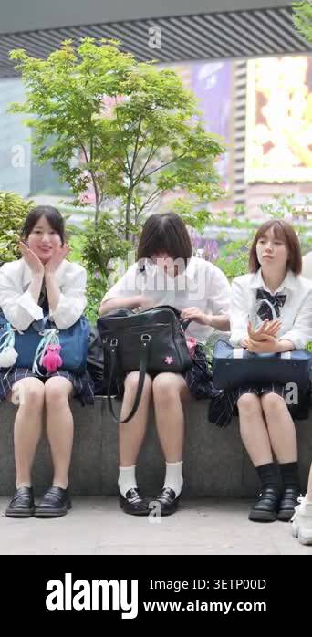 Three students sitting outdoors near trees Stock Video Footage - Alamy