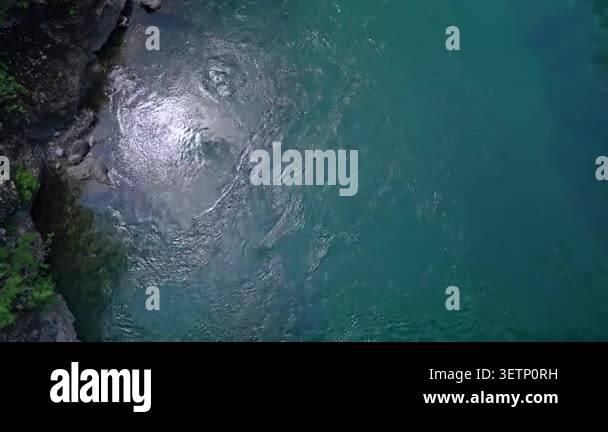 Dark turquoise water surface with gentle ripple and shimmering ...