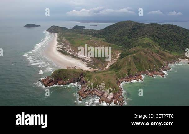 Aerial view of a beautiful island peninsula with forested hills, sandy ...