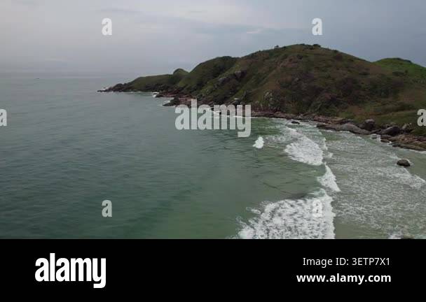 Aerial view of a beautiful coastal landscape with gentle waves meeting ...