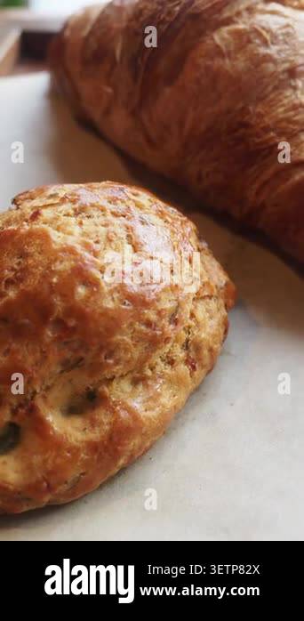 A warm scone and a loaf of bread rest on a tray after baking Stock ...