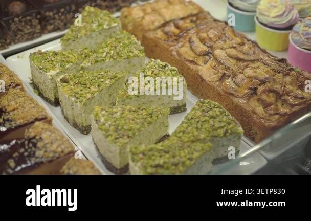 Different types of desserts are shown in a shop display case Stock ...