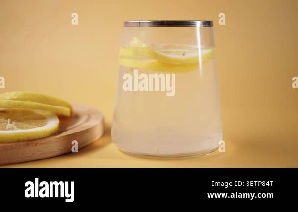 Lemon slices are added to a clear glass of water Stock Video Footage ...