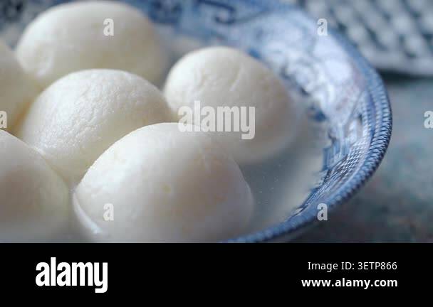 ball-shaped items are Rasgulla, a popular Bengali sweet dessert Stock ...