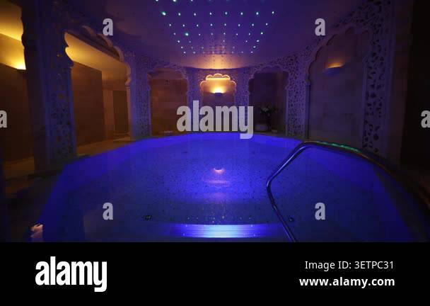 Moroccan inspired hammam shows scalloped arches, filigree panels, and a ...
