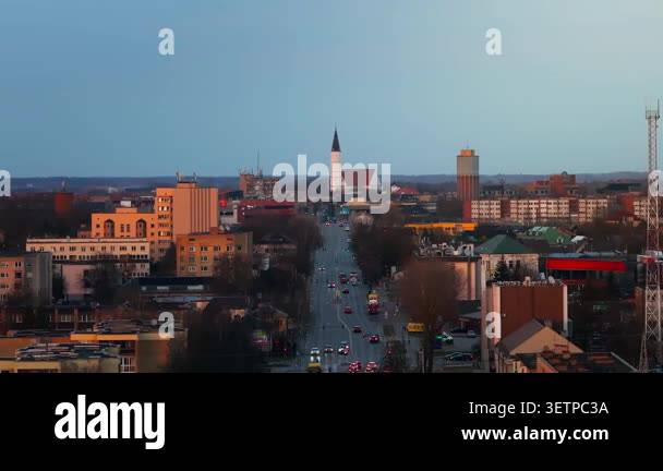Aerial city center view shows avenue to white church with black spire ...