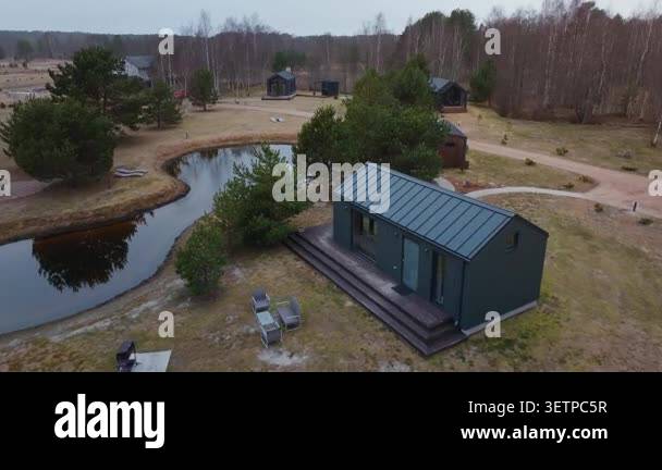 Aerial view in northern Europe shows modern tiny cabins, sauna ...