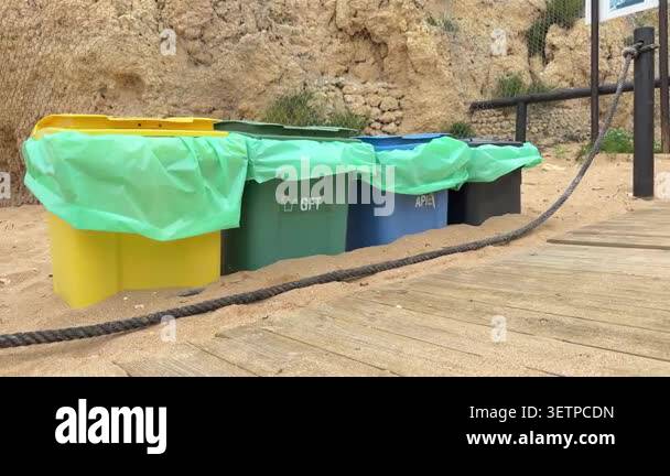 Colored recycling bins lined up outdoors, waste sorting and disposal ...