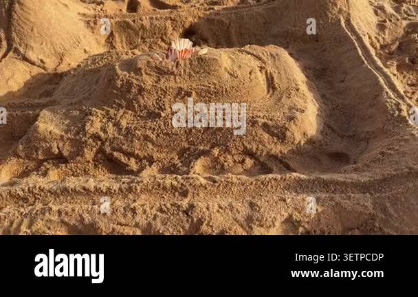 Sandcastle on beach sand, handmade summer sculpture close up Stock ...