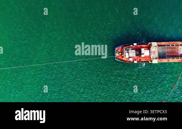 Red cargo ship with tow line viewed from directly above, Black Sea ...