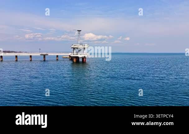 The pier structure extending into the sea. Aerial view of a concrete ...
