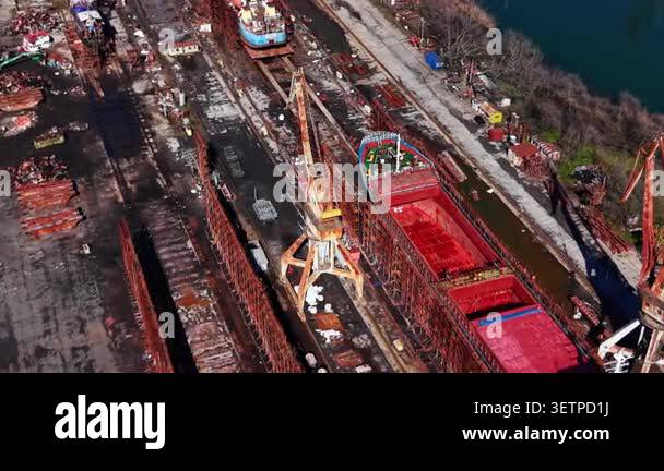 Shipyard with a vessel under repair in dry dock. High angle view of a ...