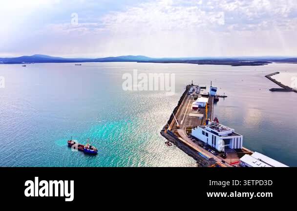 Sea port pier with cargo ship and mountain backdrop, Bulgaria. Drone ...