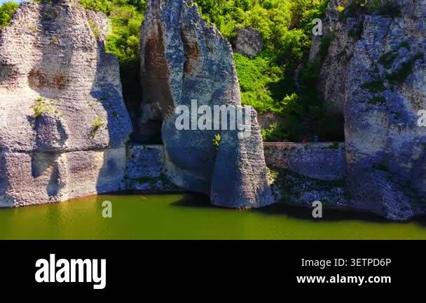Stone passage near water, Bulgaria. Narrow path between towering rock ...