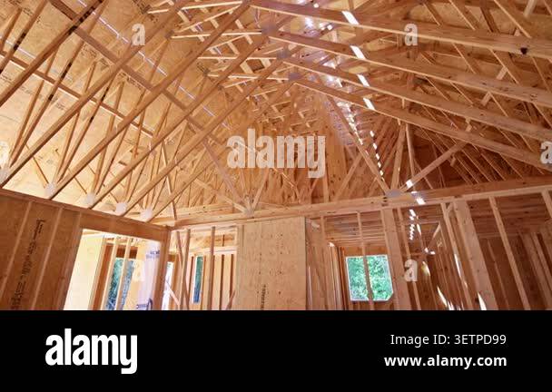 Wooden beams are arranged on roof of house as construction work is ...