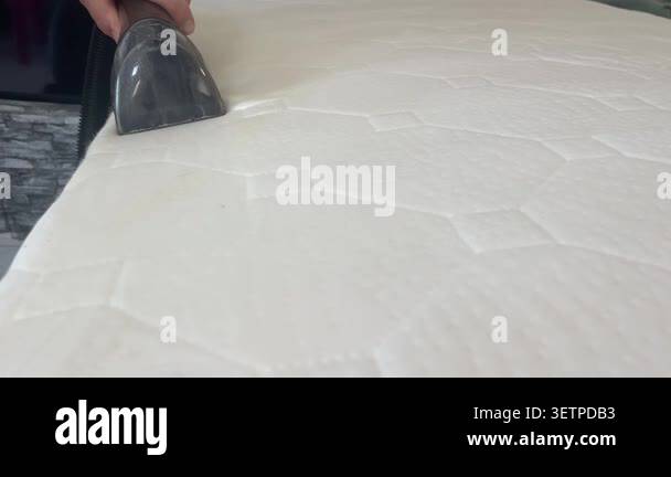 Close up horizontal shot of a water extraction vacuum nozzle cleaning a ...