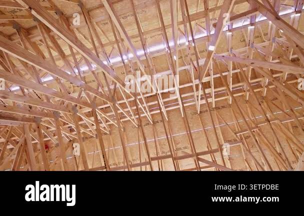 Workers are building house with wooden beams frames, trusses roof ...