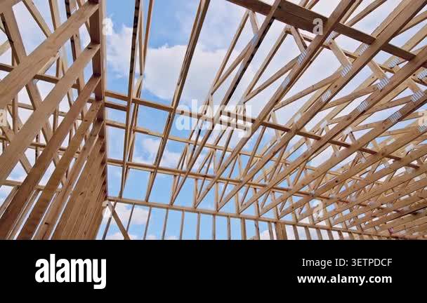 Workers are building wooden roofing beams frame structure at ...
