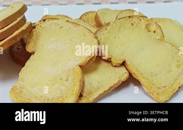 Close up of mini crispy toast rusks stacked on white surface Stock ...