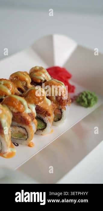 Set of tasty uramaki sushi rolls served with pickled ginger and wasabi ...