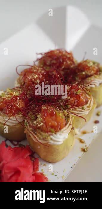 Close-up of exquisite uramaki sushi rolls with salmon tartare, cream ...