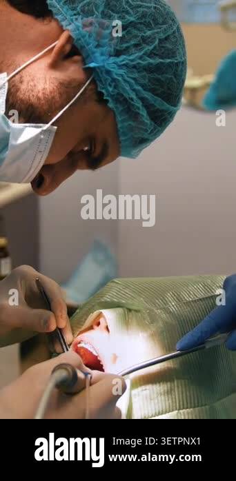 Doctor examining a patient with a retractor in the dental office ...